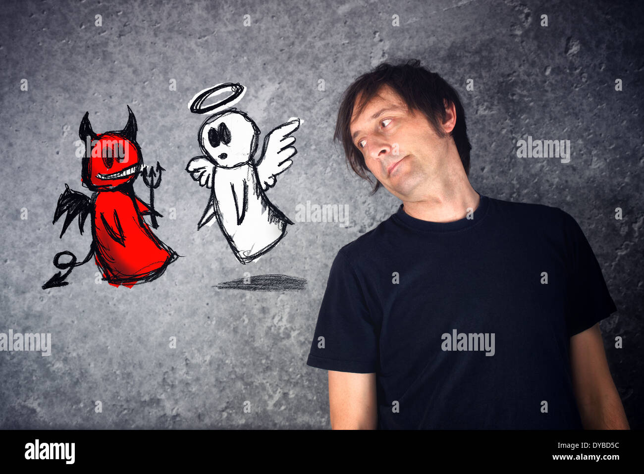 Casual man looking at doodle drawing of angel and devil fighting ...