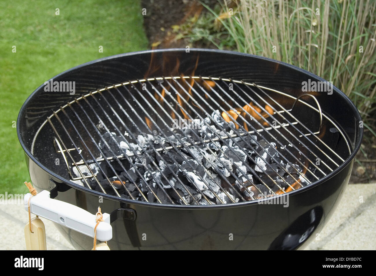 coal burning and getting ready for summer BBQ Stock Photo - Alamy