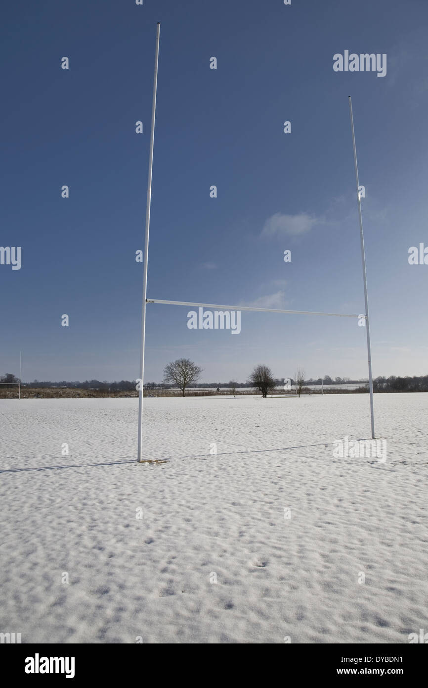 winter snow scene showing a snow covered sports field with rugby goal ...