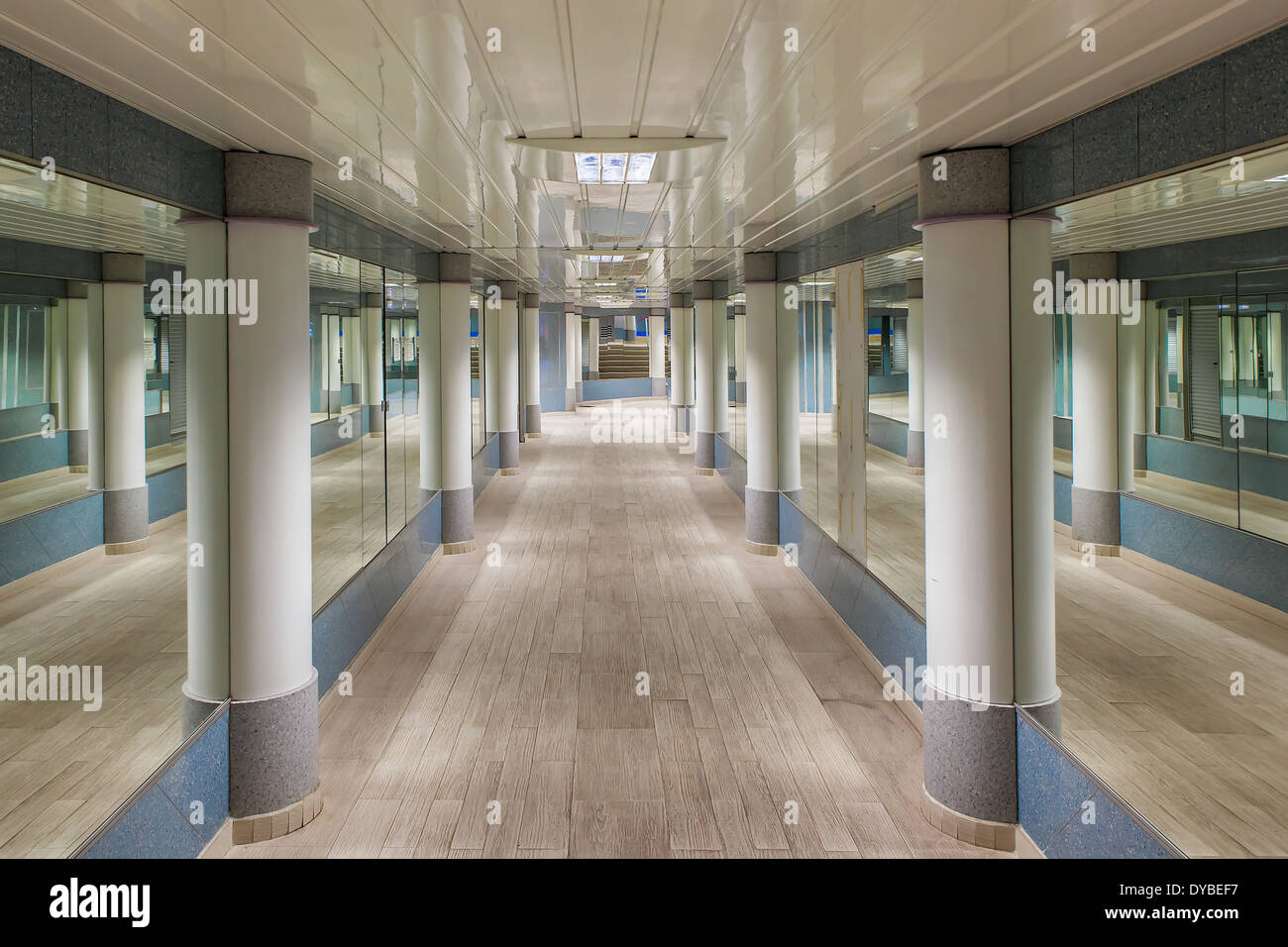 View of modern underground pedestrian passage with mirrors on walls in ...