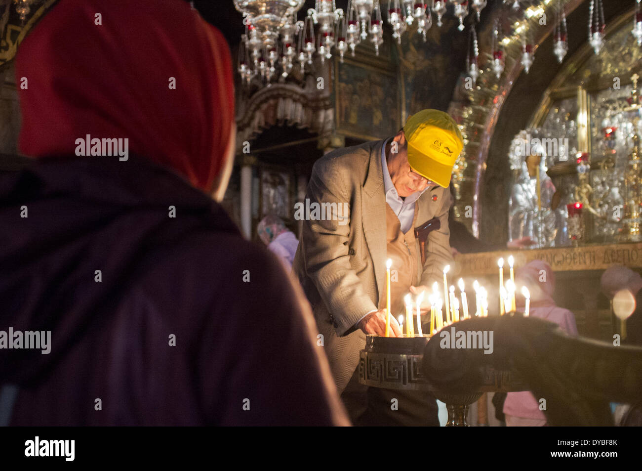 Jerusalem, Middle East. 13th Apr, 2014. A Christian devotee lights ...
