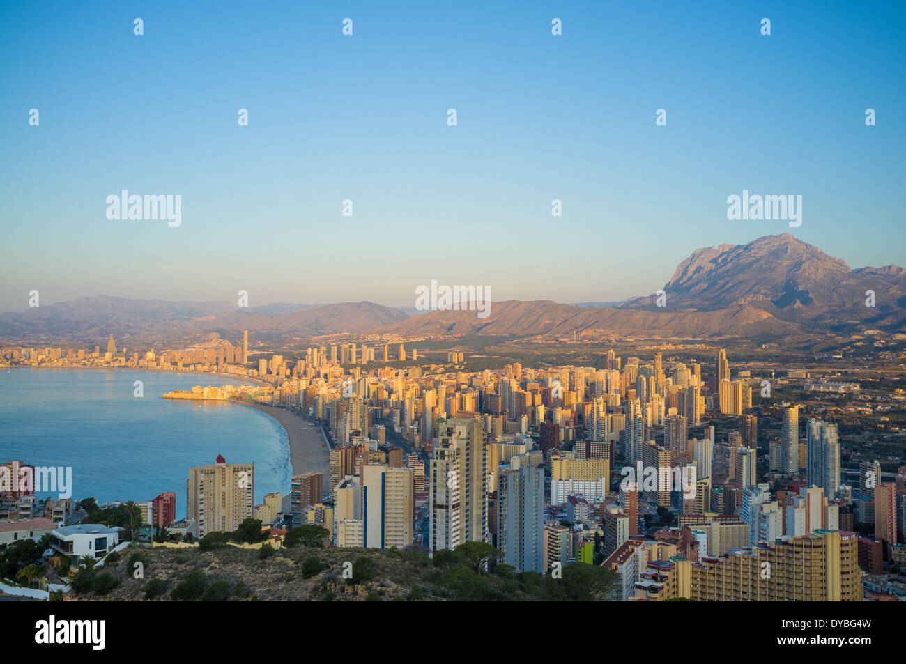 The first early morning sun starting to light Benidorm skyline, Costa ...