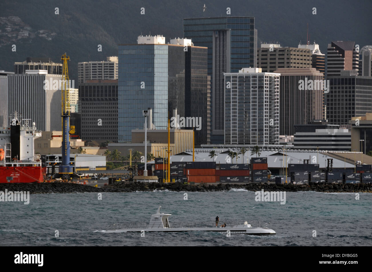Recreational submarine cruising along Honolulu port docks and shoreline ...