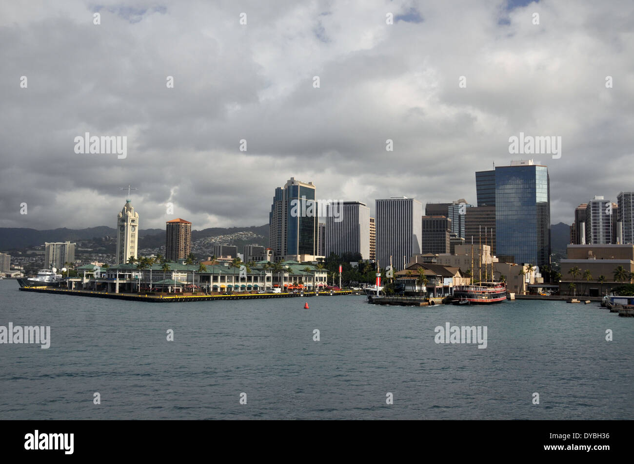 Aloha Tower and downtown Honolulu viewed from the ocean in a cloudy day ...