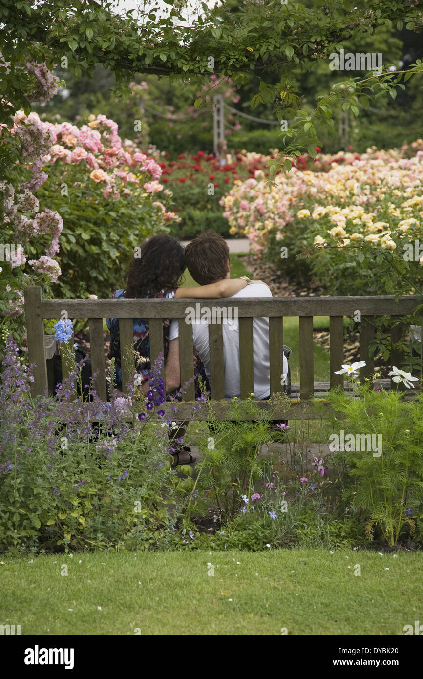 young couple cuddling together on a wooden bench Stock Photo - Alamy