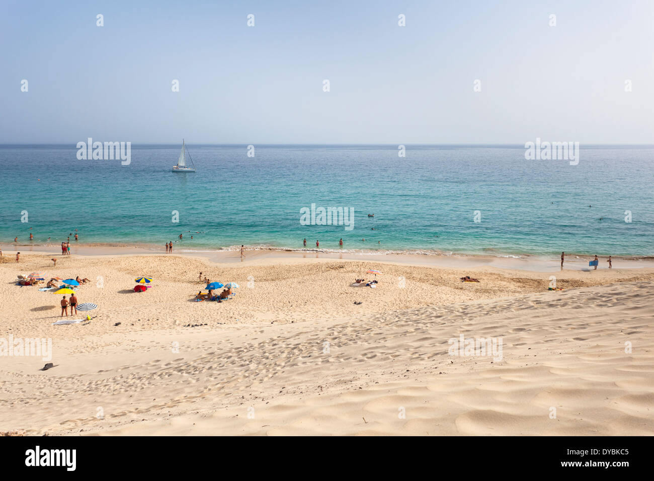 Jandia Beach in Morro Jable with some tourists and a sailboat in the ...