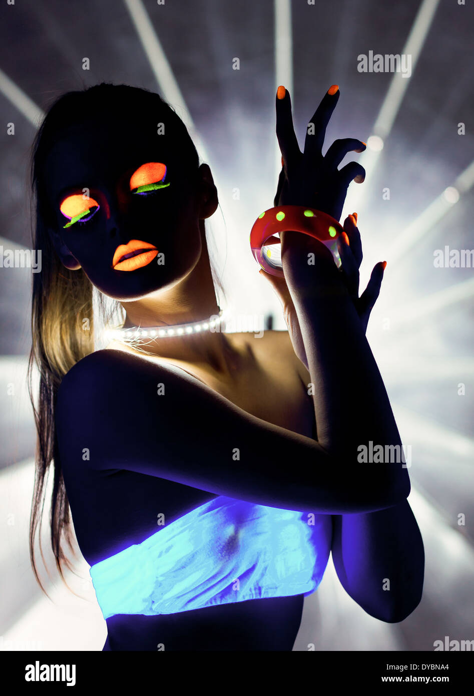 Disco girl with glow make-up dance in uv light Stock Photo - Alamy