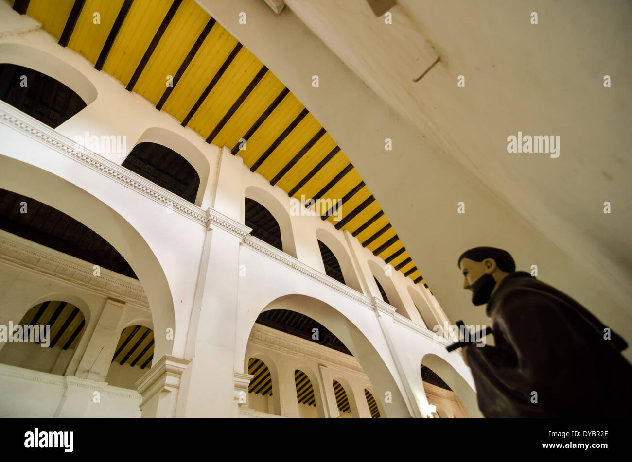 Interior of a simple white church with a statue Stock Photo - Alamy