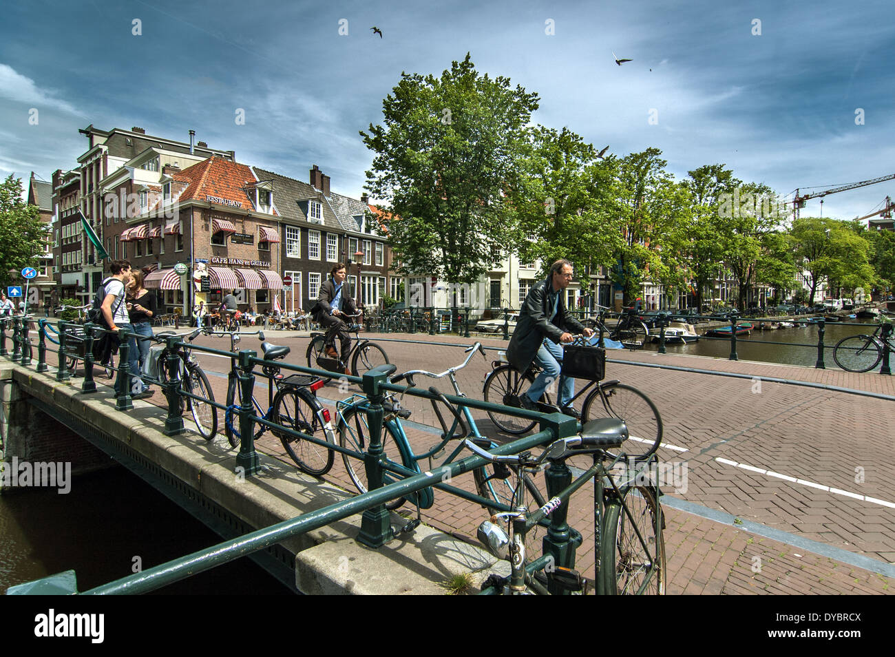 Bikers riding over the bridge in Amsterdam Stock Photo - Alamy