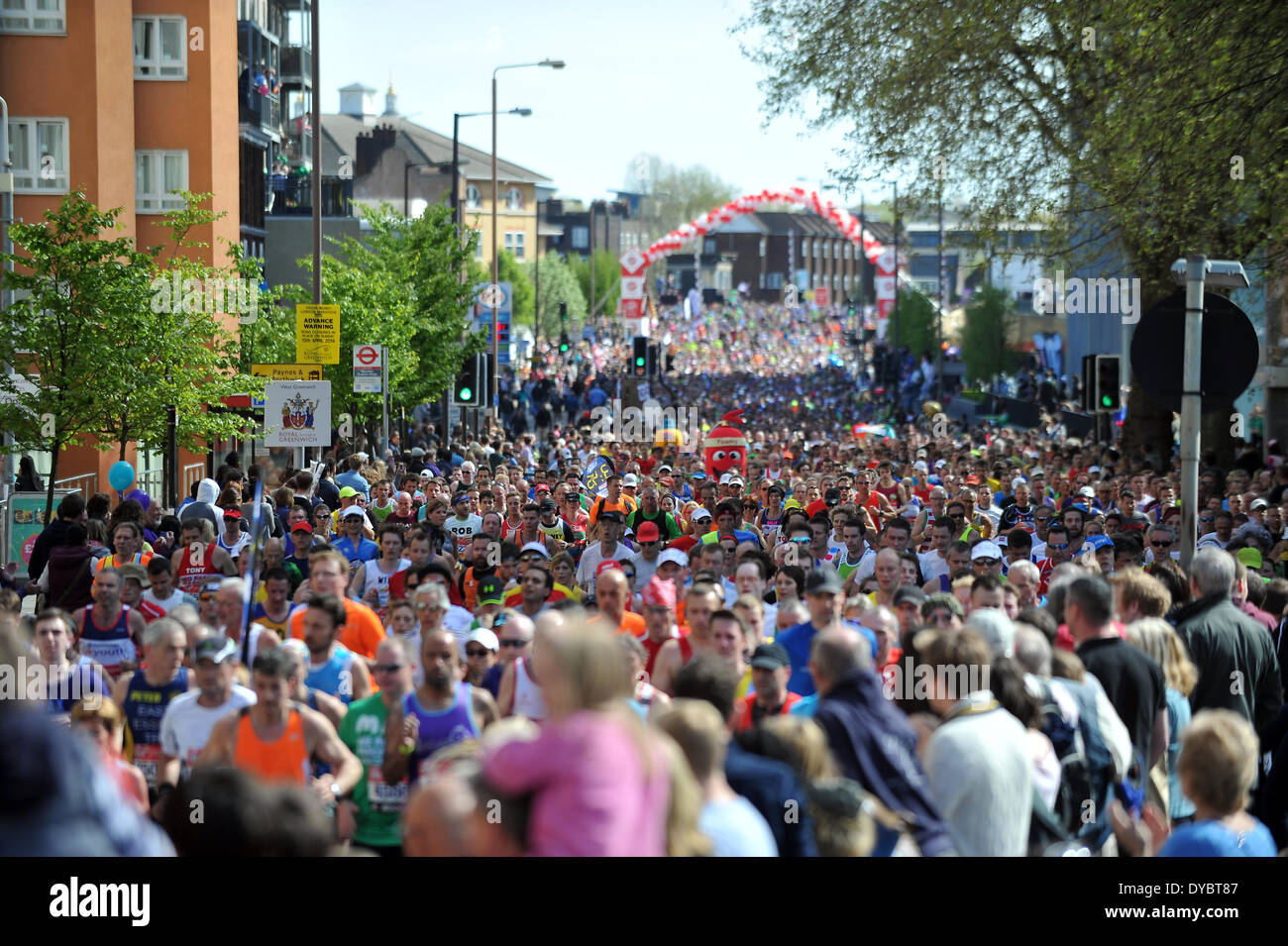 London, UK, 13th Apr, 2014. Runners and spectators crowd the streets ...