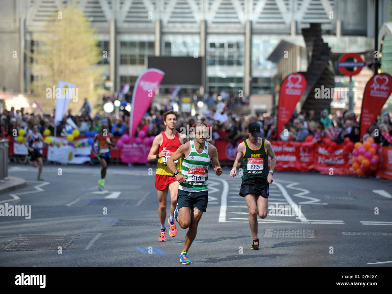London, UK, 13th Apr, 2014. Runners and spectators crowd the streets ...