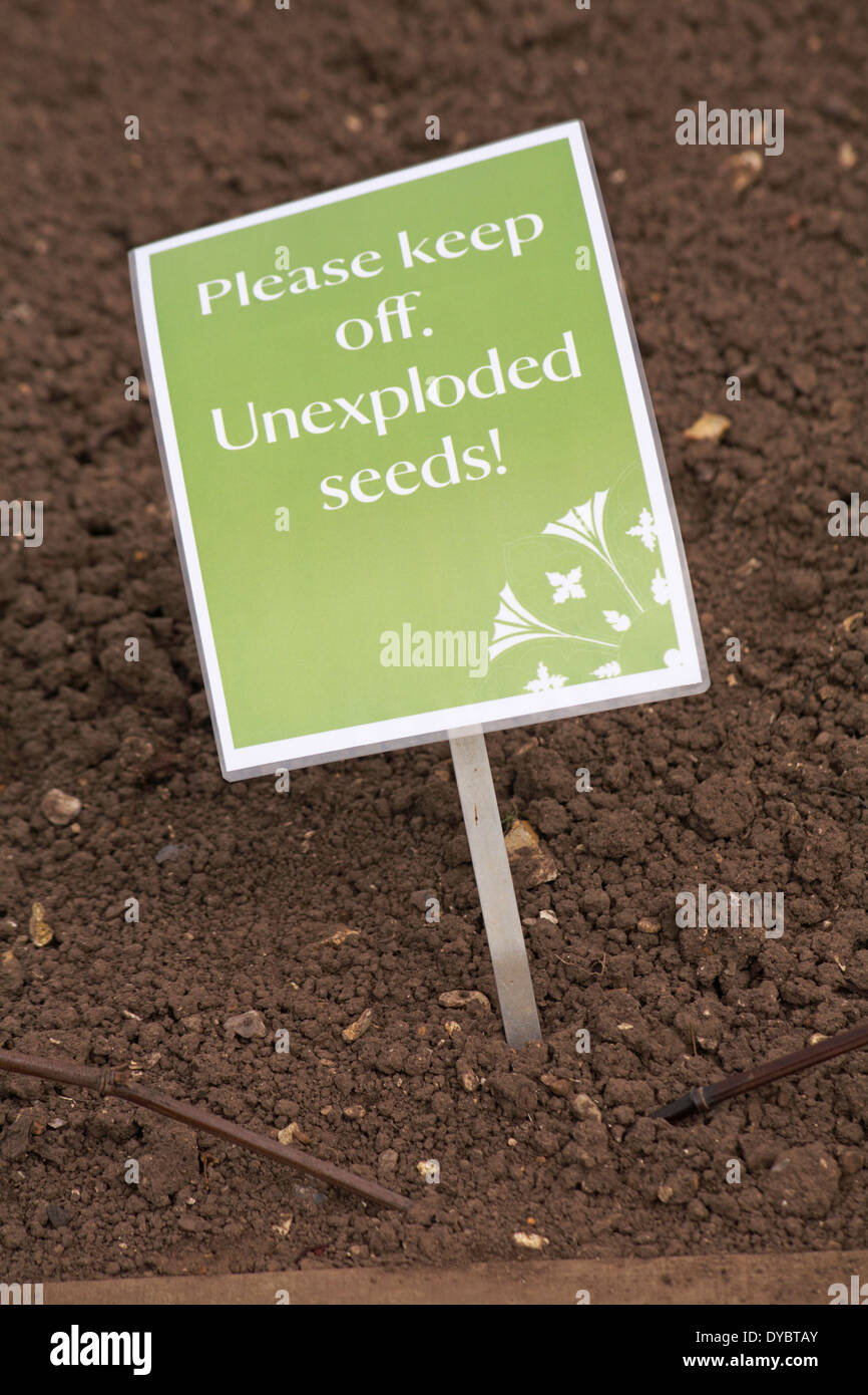 please keep off unexploded seeds sign on bare ground Stock Photo - Alamy