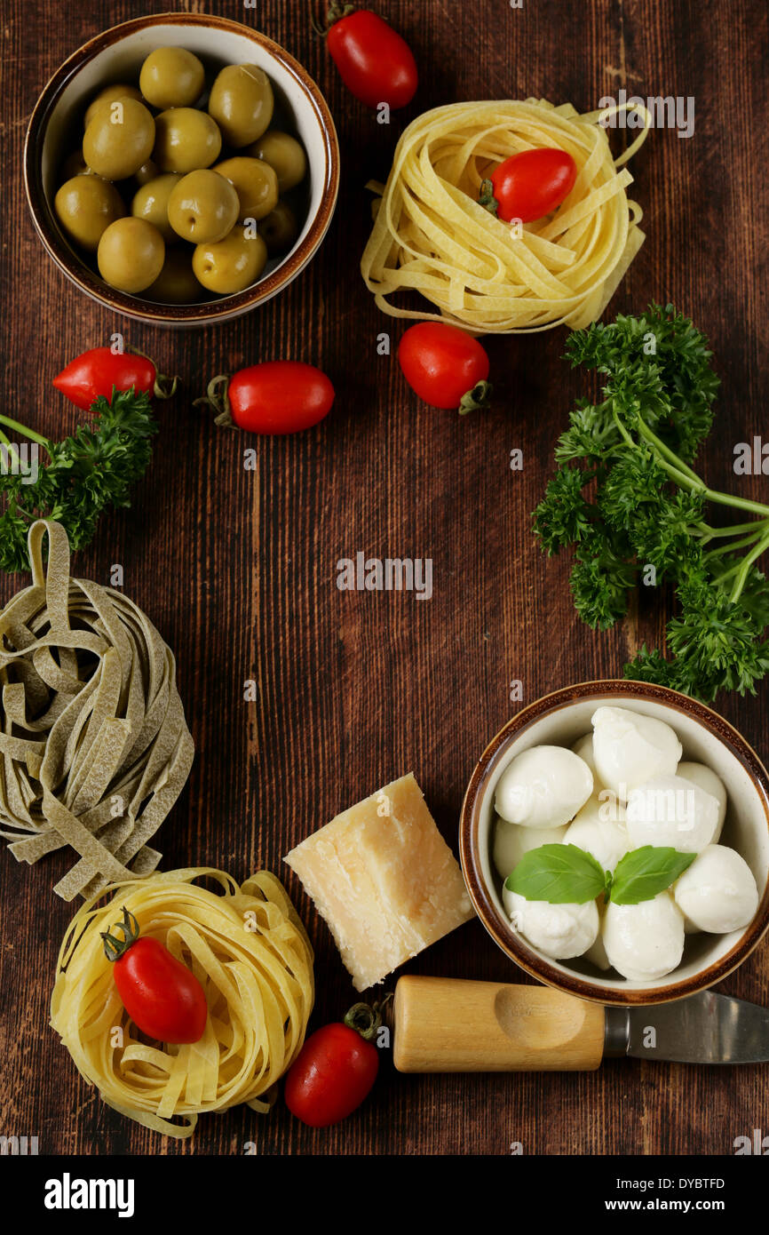 Italian still life - olives, mozzarella cheese, pasta, tomatoes Stock ...