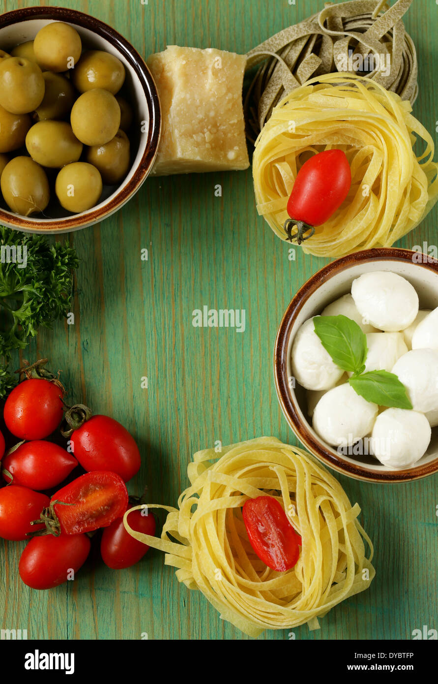 Italian still life - olives, mozzarella cheese, pasta, tomatoes Stock ...