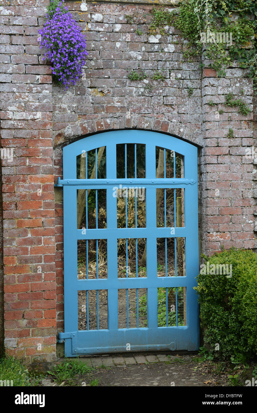 Blue garden gate in walled garden Uk Stock Photo - Alamy