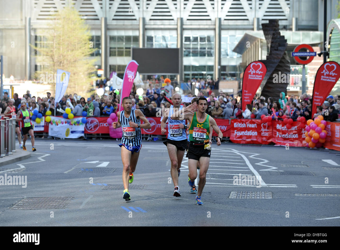 London, UK, 13th Apr, 2014. Runners and spectators crowd the streets ...