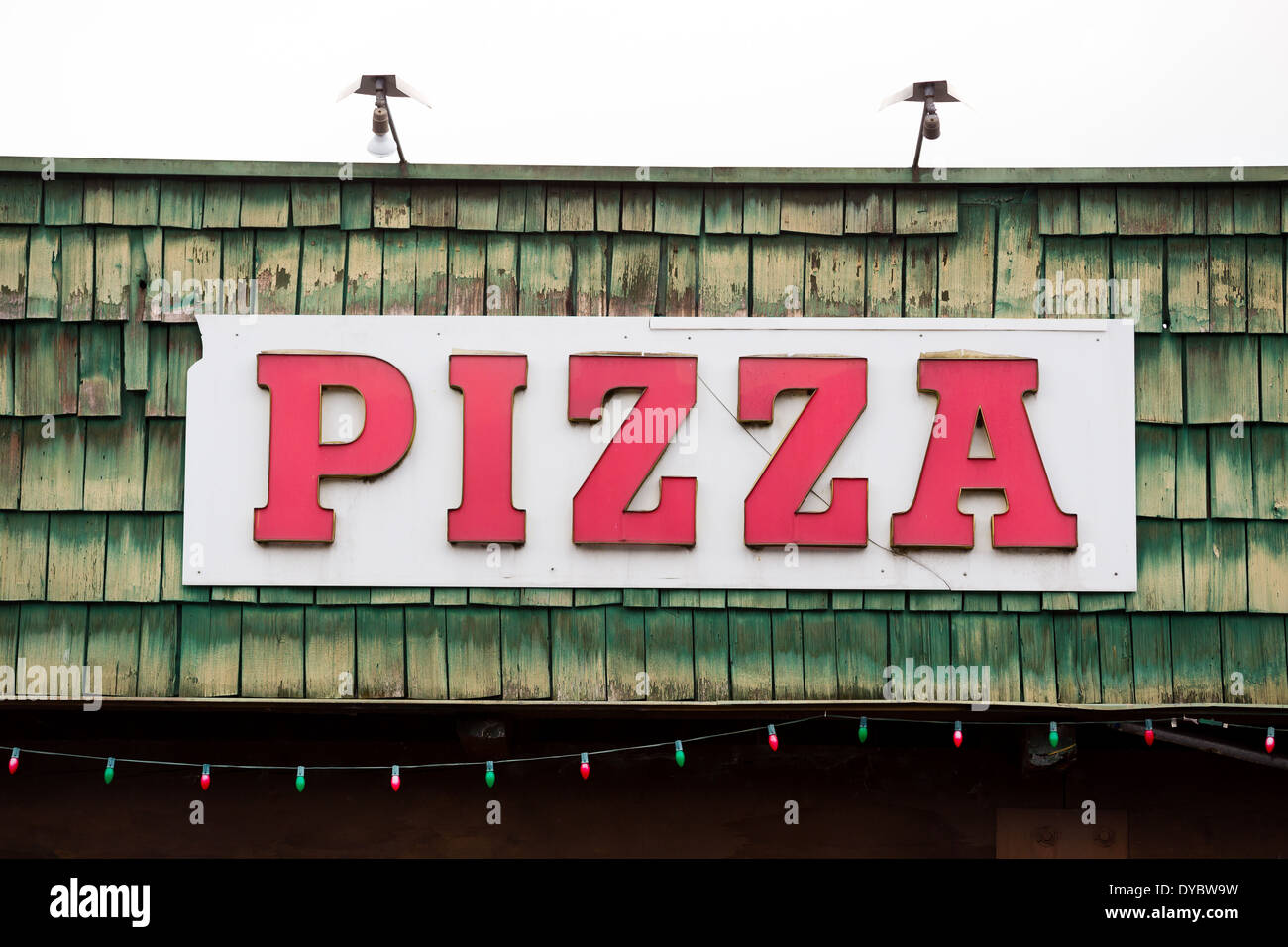 Weathered pizza restaurant sign with red and green Stock Photo - Alamy