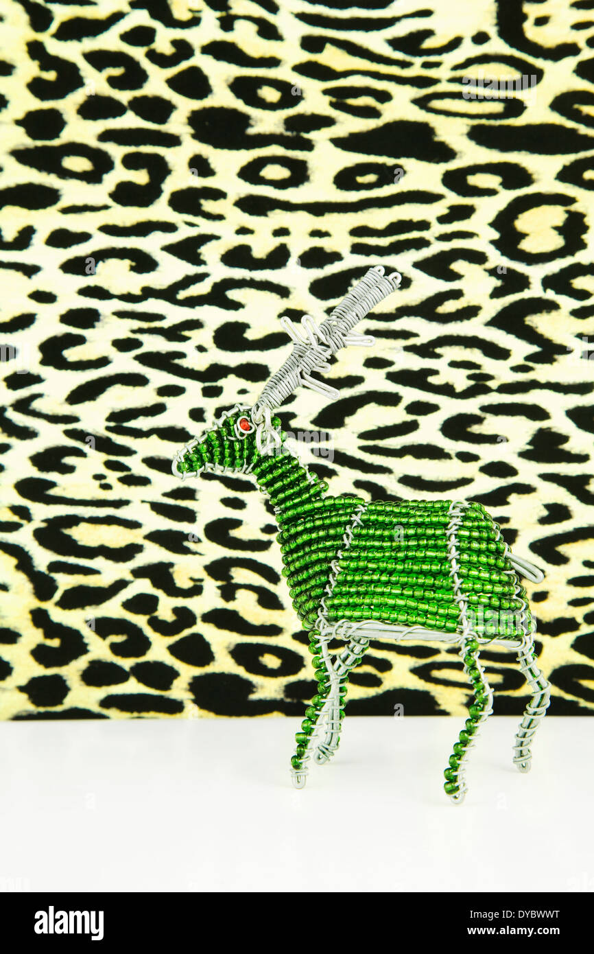 Wired and beaded African animal Craft of a Buck isolated on a leopard ...