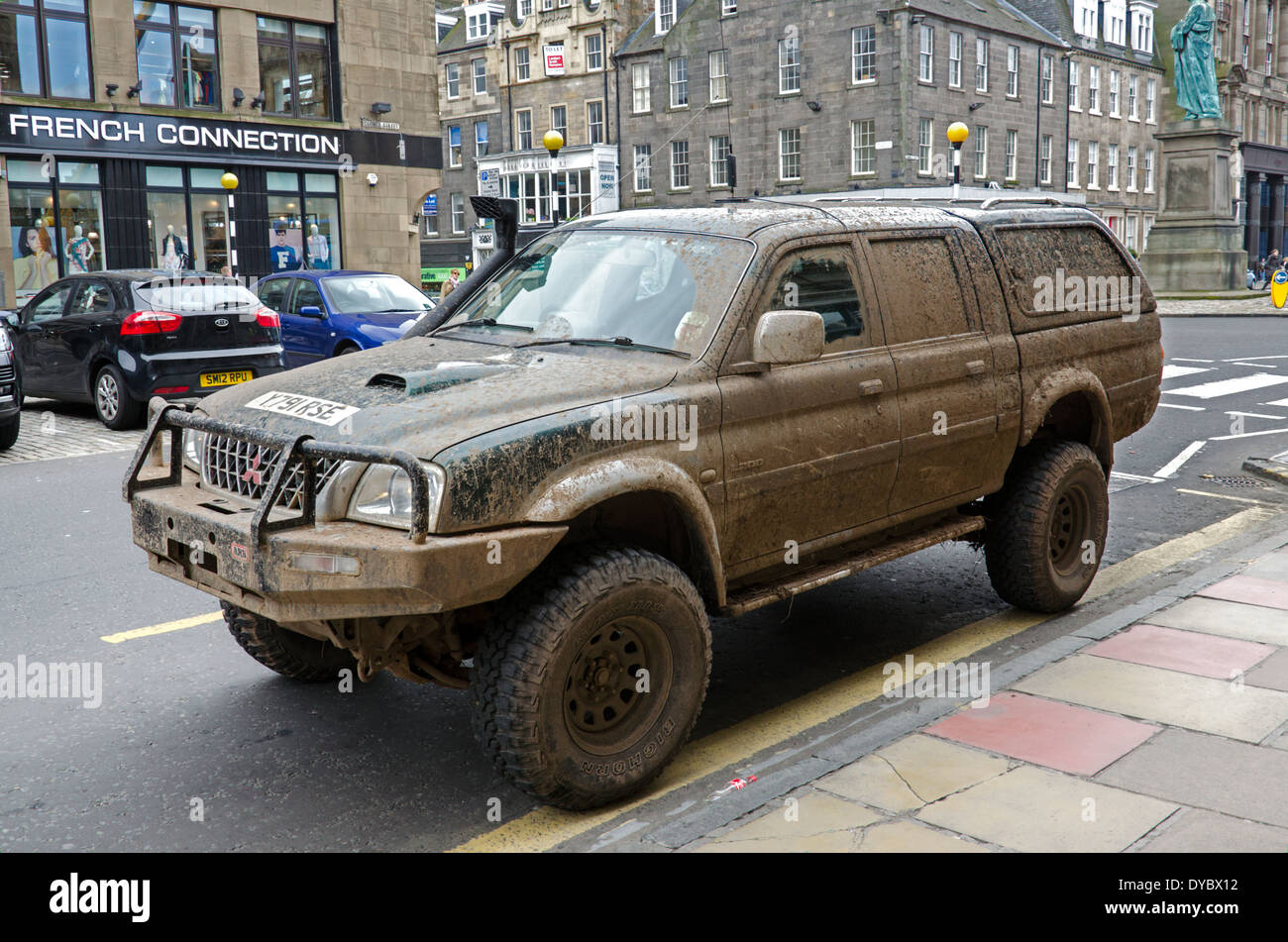 A very muddy Mitsubishi Shogun parked in George Street in the center of ...