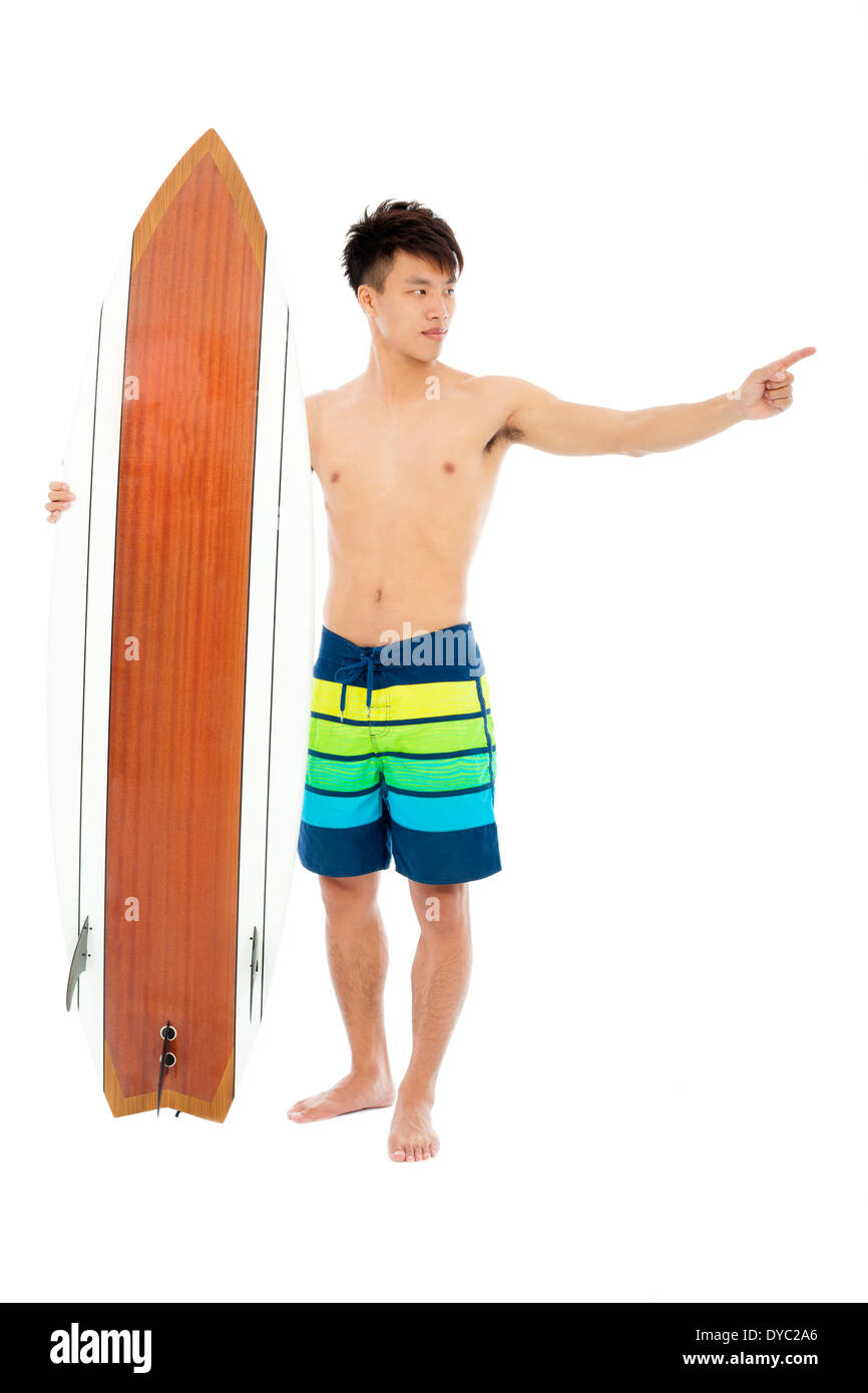 young man standing and point forward with surfboard Stock Photo - Alamy