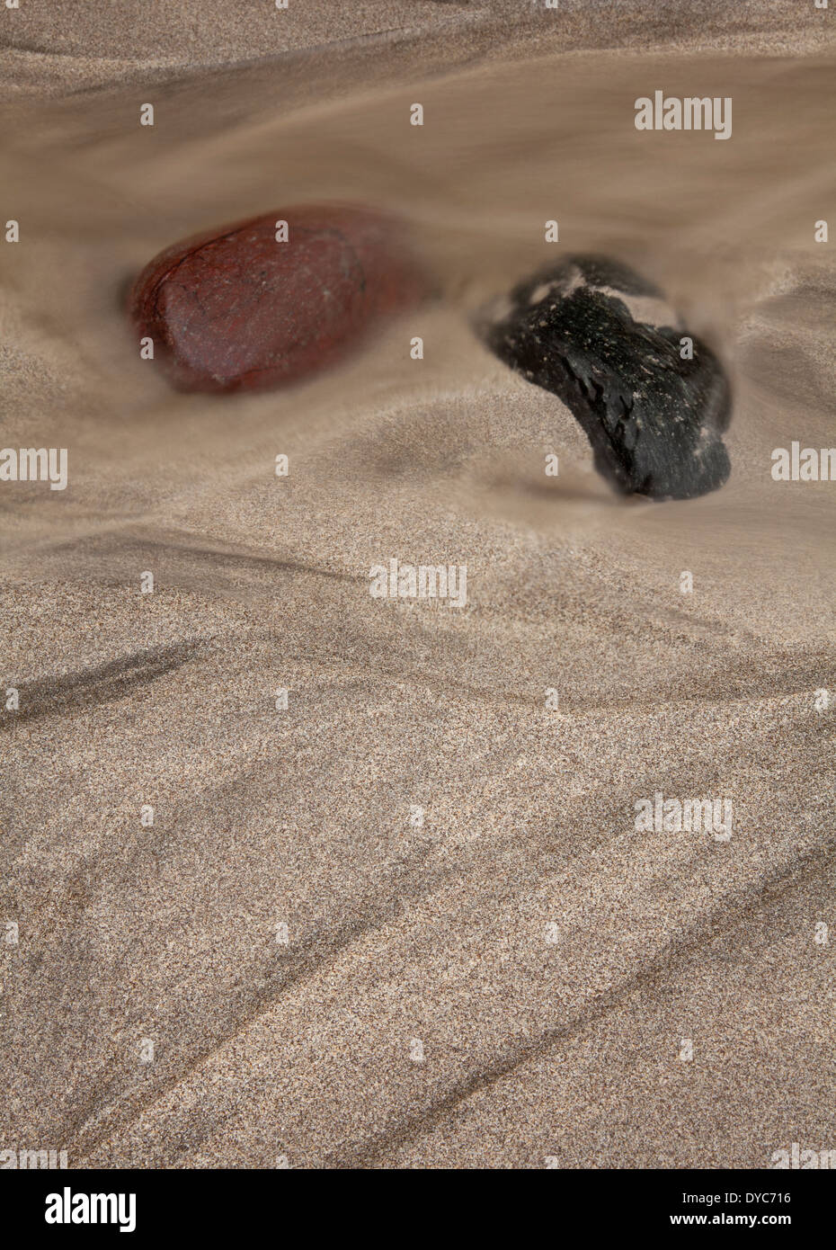 Stones on Sand and Water Stock Photo - Alamy