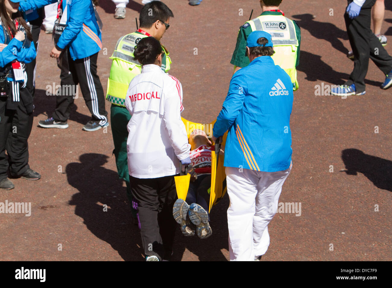 London,UK,13th April 2014,A male runner collapses after finishing the ...