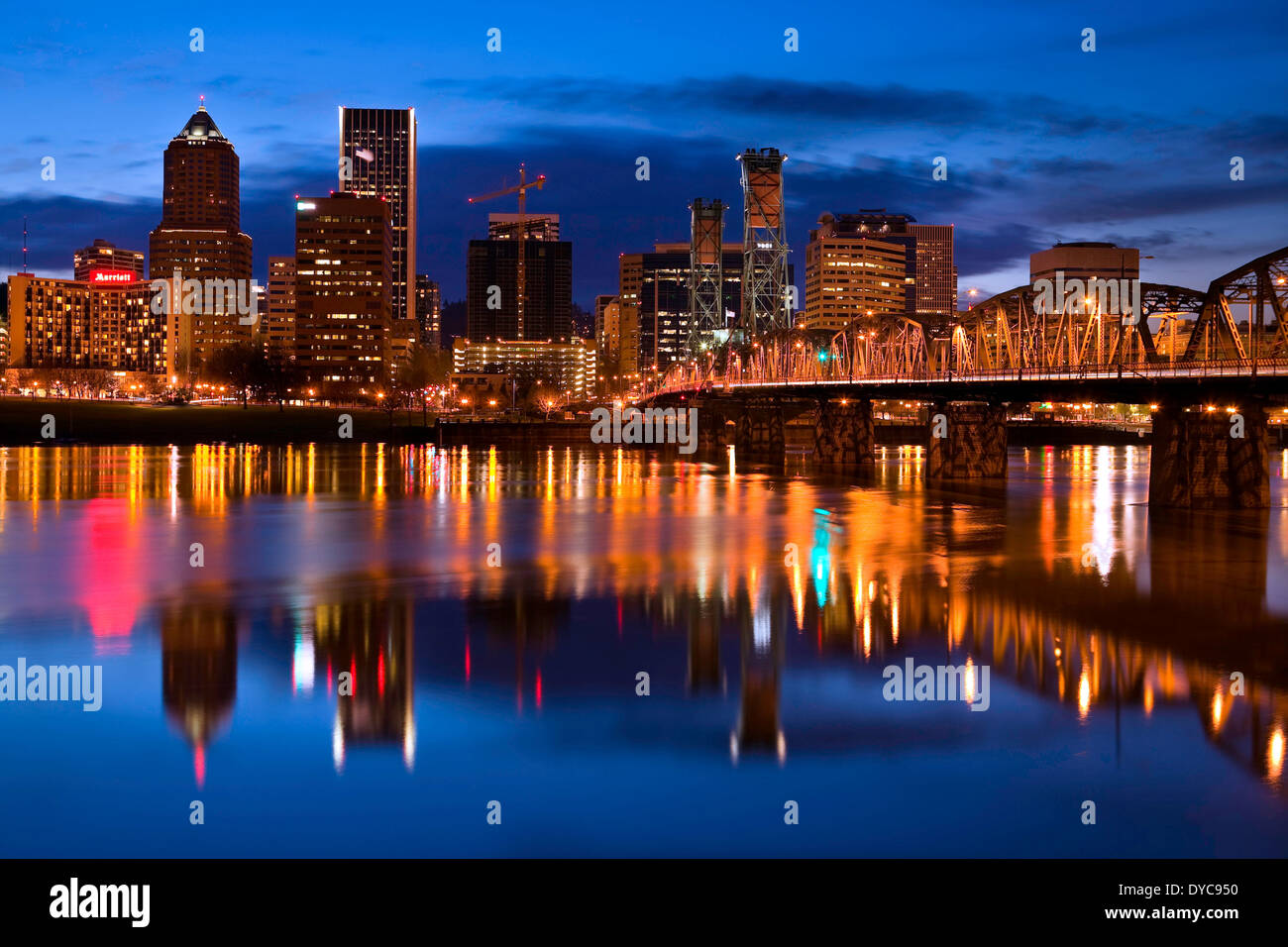 Downtown Portland, Oregon reflects off the Willamette River early in ...