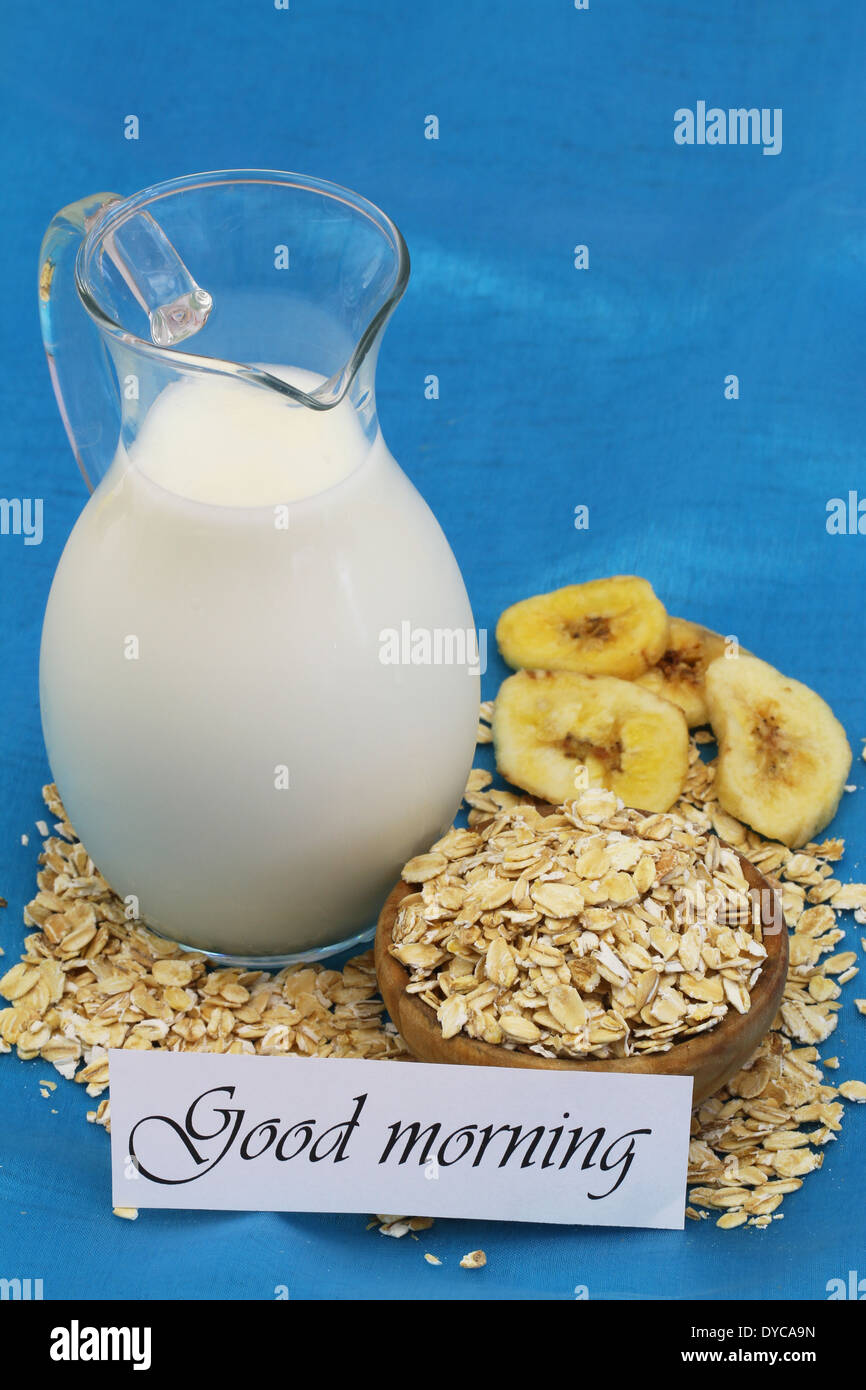 Good morning card with oatmeal, banana chips and jug of milk on blue ...