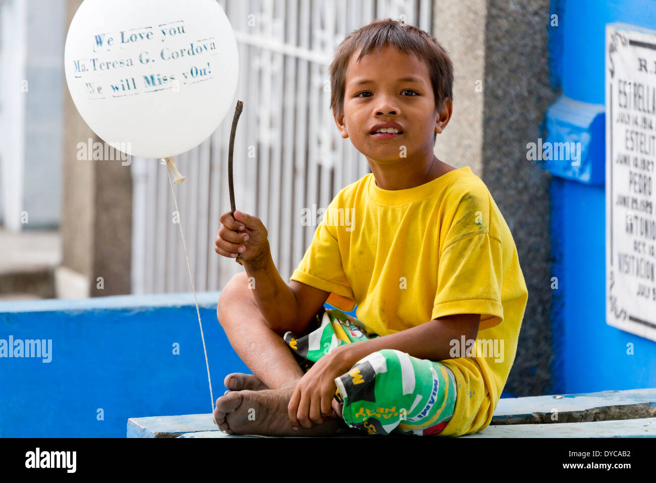Boy sitting on a Grave on the North Cemetery in Manila, Philippines ...