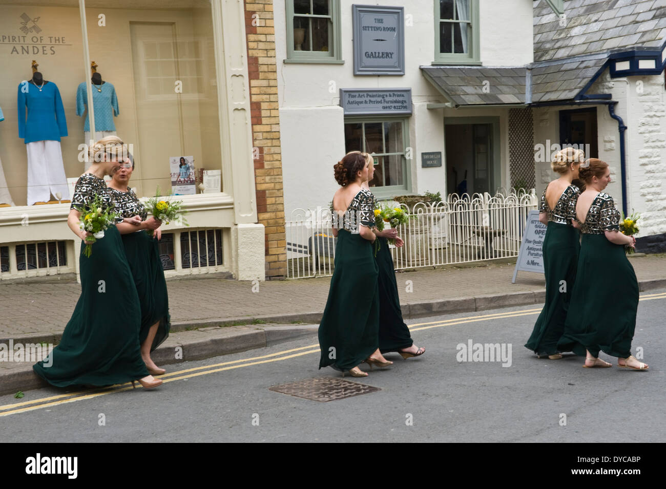 Bridesmaids walking in wedding procession through Hay-on-Wye Powys ...