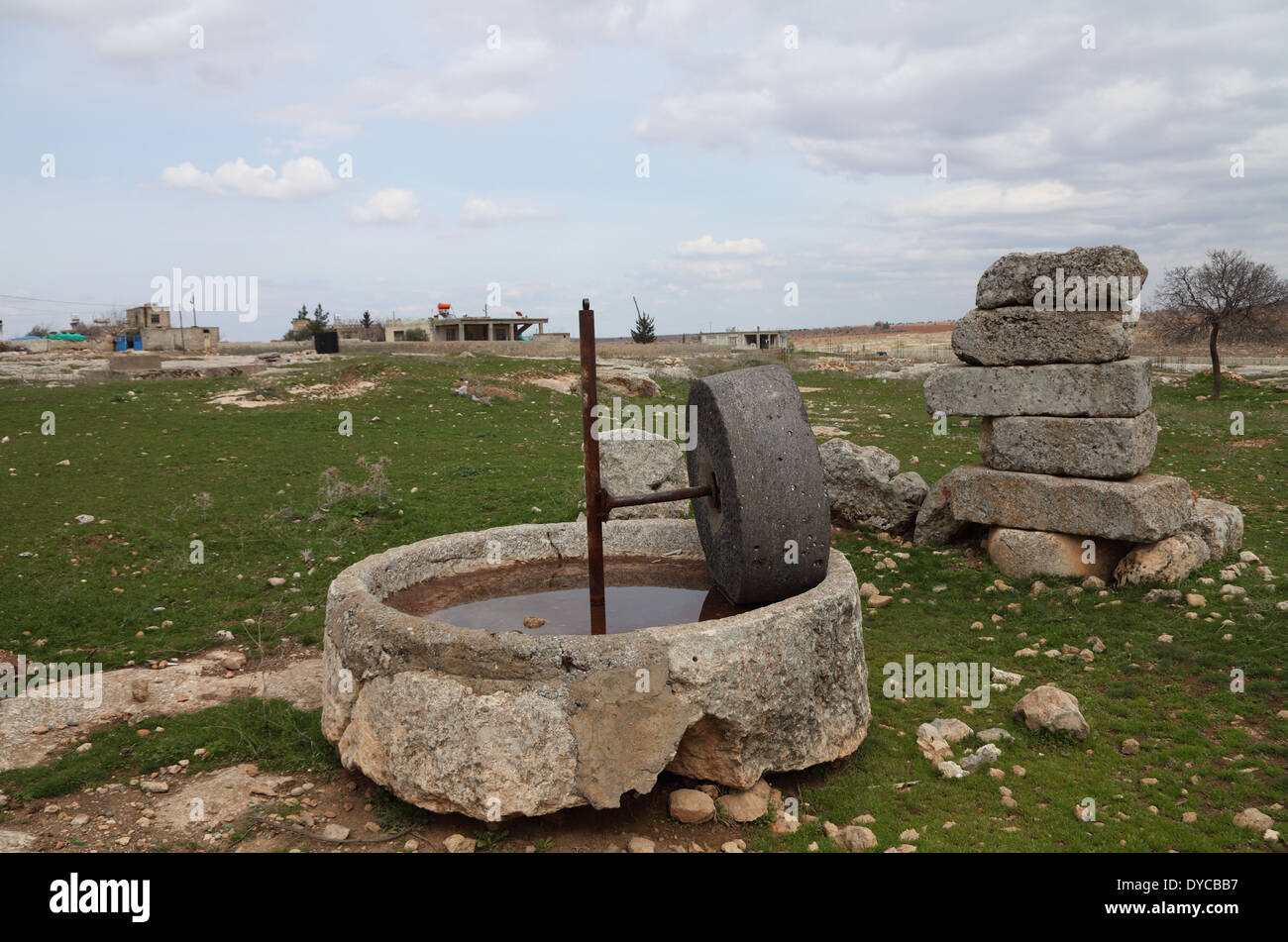 Old grindstone in a landscape of ancient water cisterns in the bedrock ...