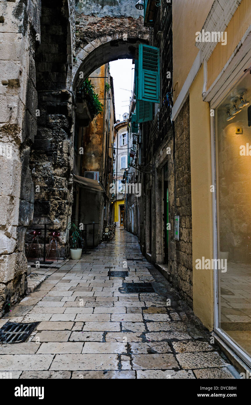 An ancient marble path runs between the walls of tall buildings ...