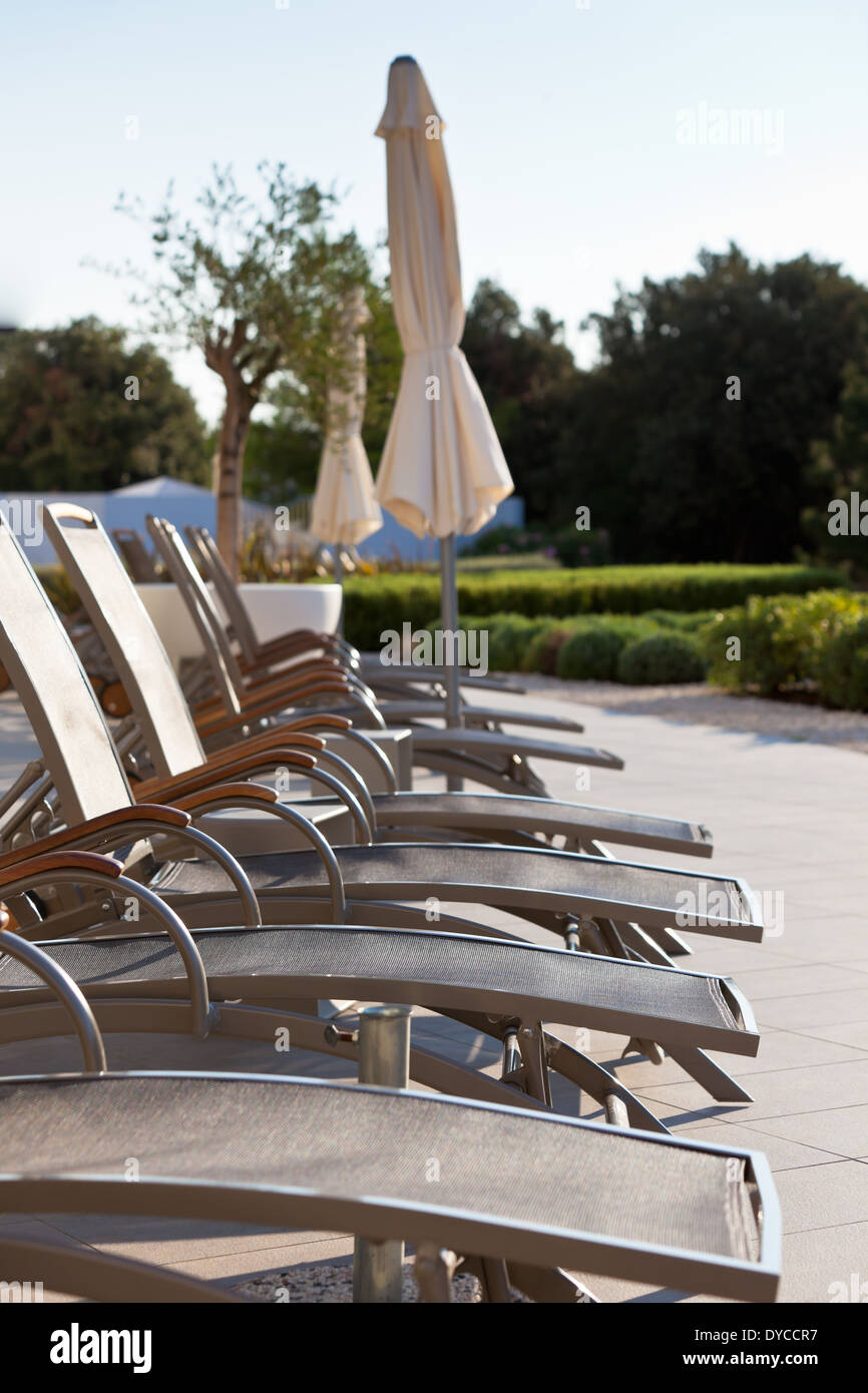 Hotel Poolside Chairs Row. Vertical shot Stock Photo - Alamy