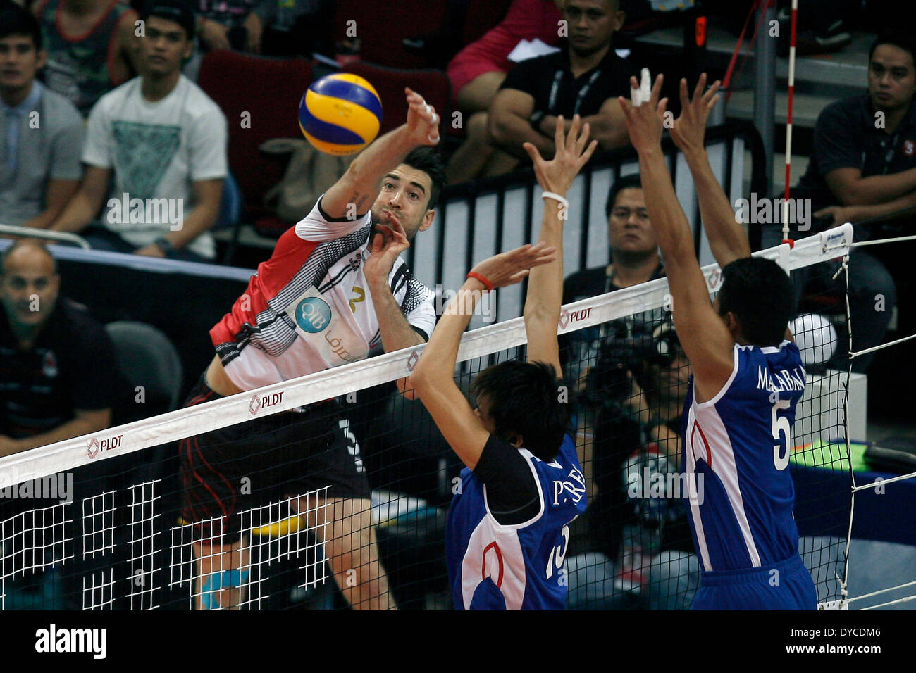Pasay City, Philippines. 14th Apr, 2014. Cristian Savani of Qatar (L) spikes the ball against ...