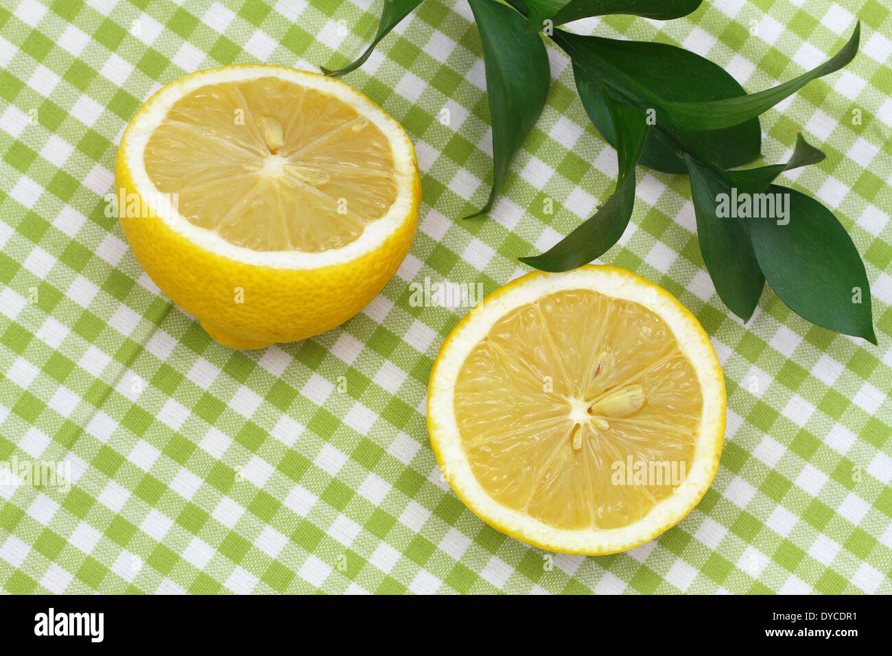 Lemon halves on green checkered cloth Stock Photo - Alamy