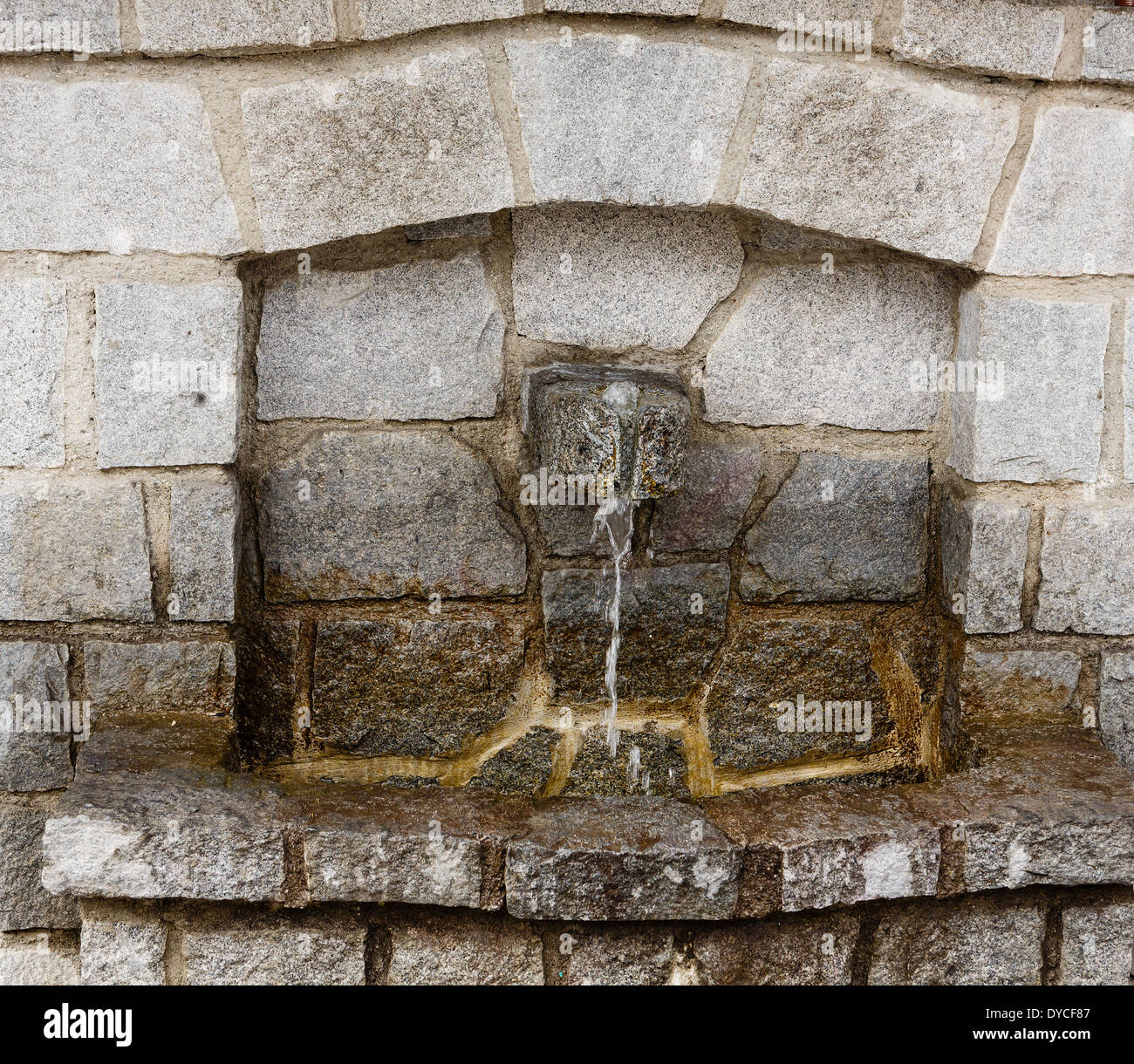 Source of water in a stone wall Stock Photo - Alamy