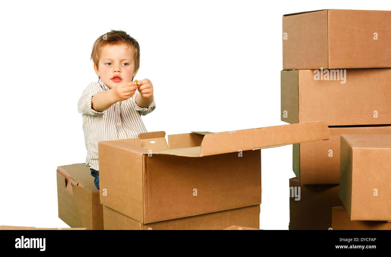 little boy plays in boxes Stock Photo - Alamy