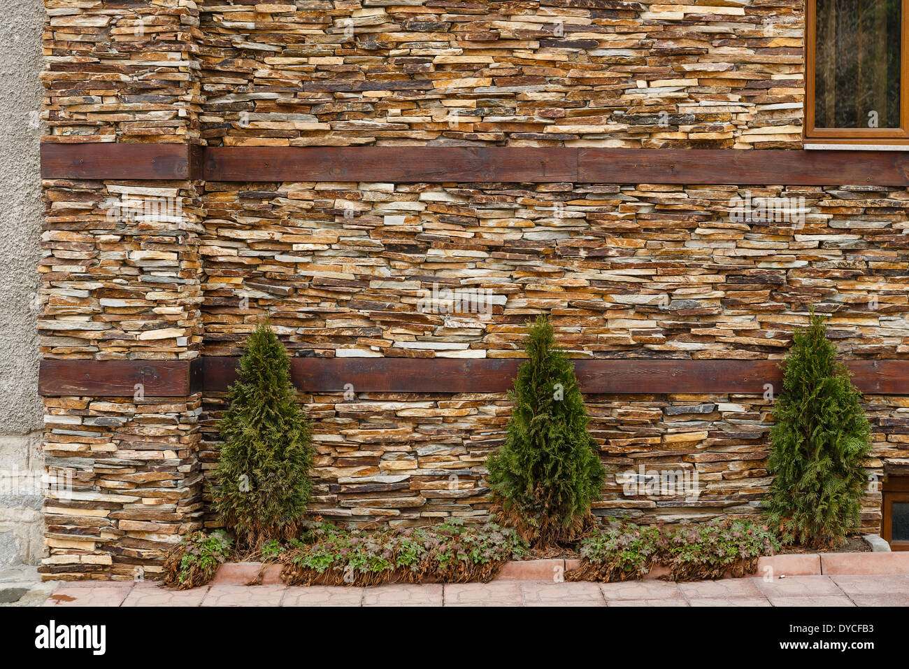 House wall decorated by stones and wooden panels Stock Photo - Alamy