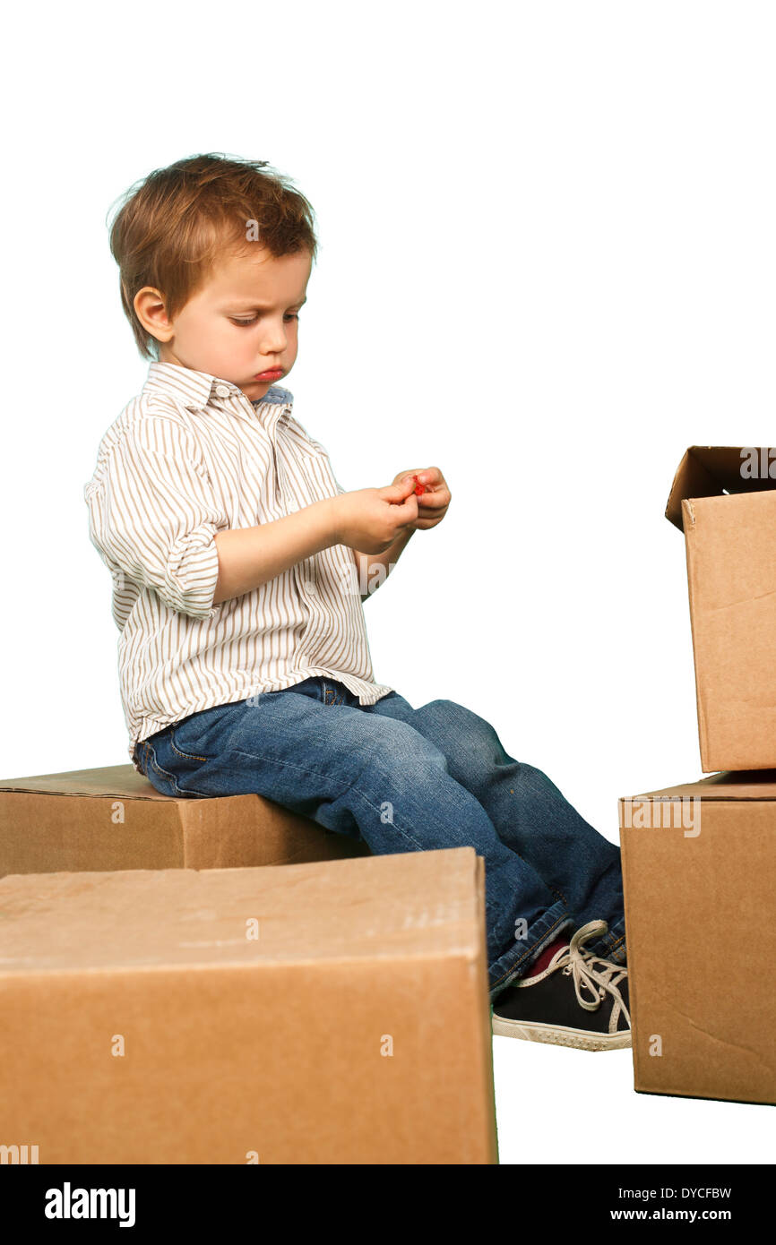little boy plays in boxes Stock Photo - Alamy