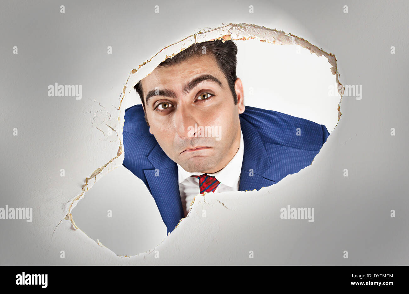 Man looking through a hole in the ceiling Stock Photo - Alamy