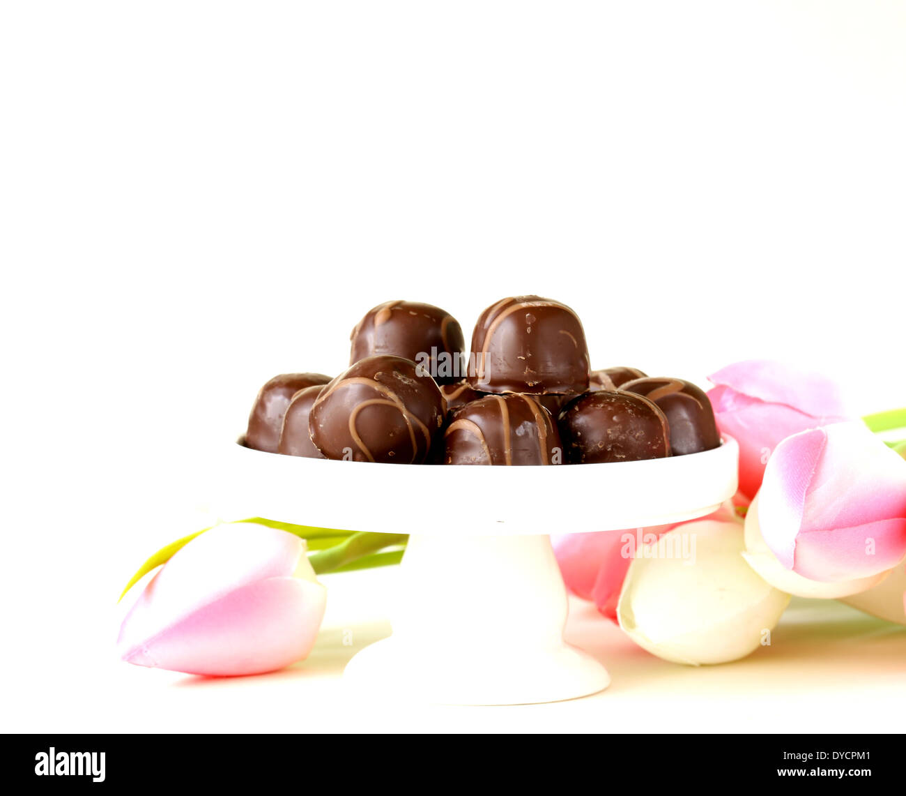chocolate candy and flowers on white background Stock Photo - Alamy