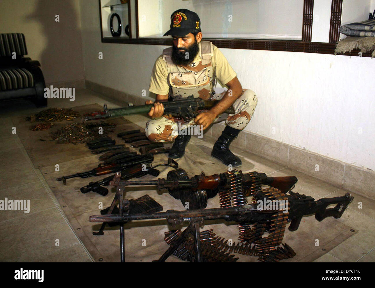 Karachi. 14th Apr, 2014. A Pakistani ranger displays seized weapons in ...