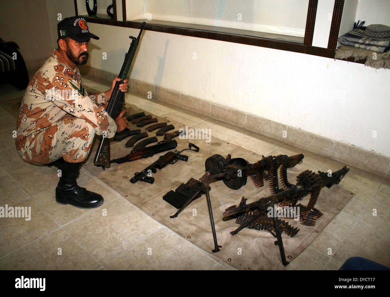 Karachi. 14th Apr, 2014. A Pakistani ranger displays seized weapons in ...