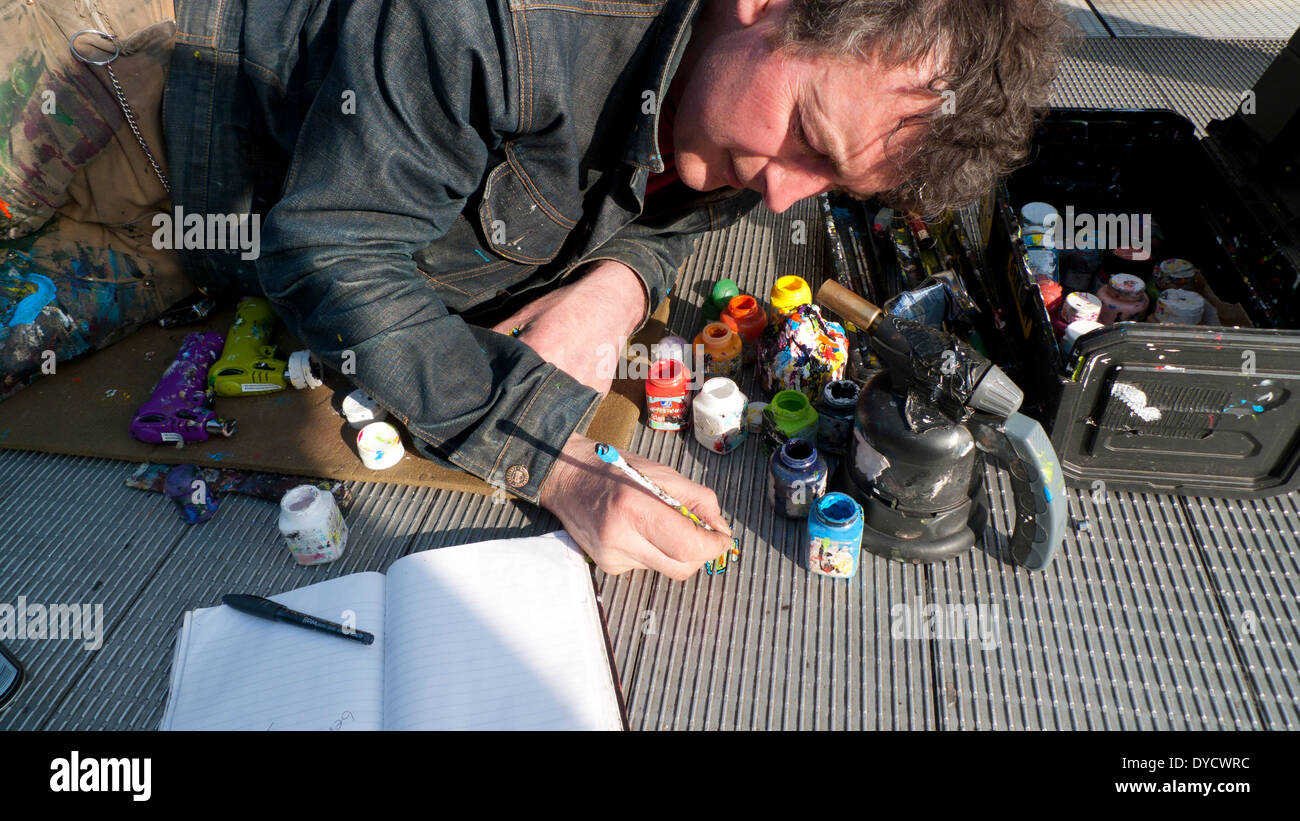 British chewing gum artist Ben Wilson painting while lying on ...