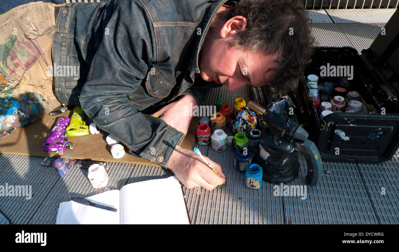 British chewing gum artist Ben Wilson painting while lying on ...