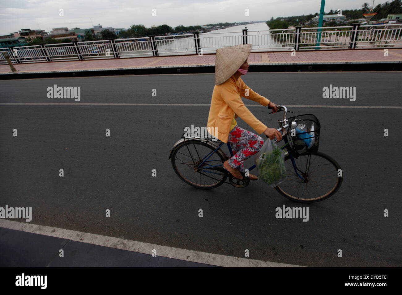 Woman rides a bike in Ben Tre, Vietnam Stock Photo - Alamy