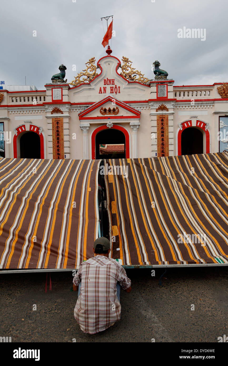A man set up tent in front of a temple in Ben Tre province, Vietnam ...