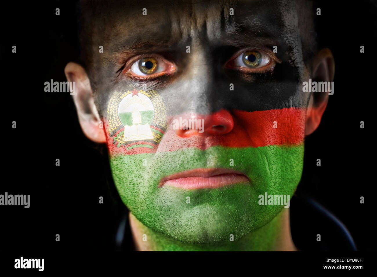An intense stare from a man with their face painted with the ...