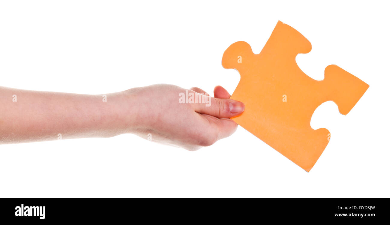 female hand holding big yellow paper puzzle piece isolated on white ...