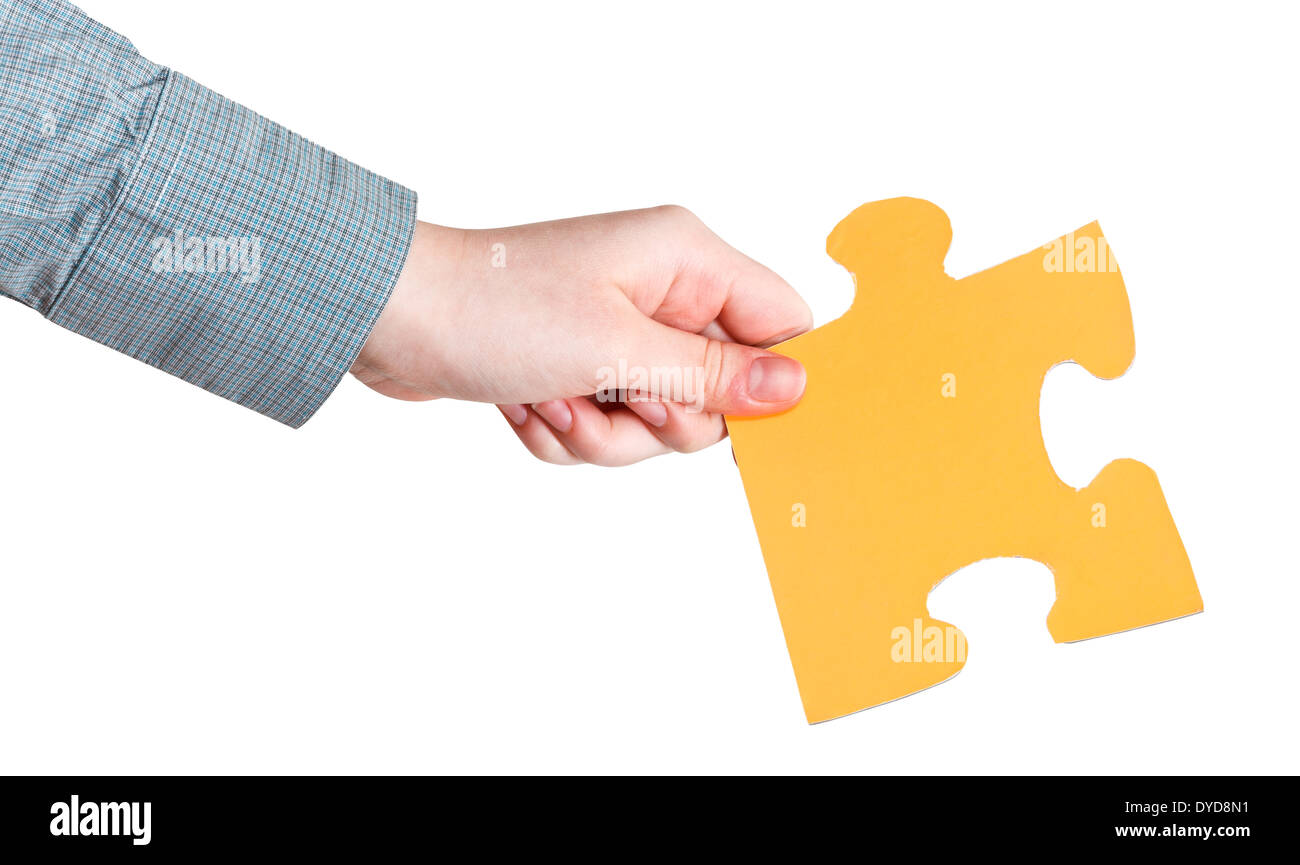 female hand holding big yellow paper puzzle piece isolated on white ...